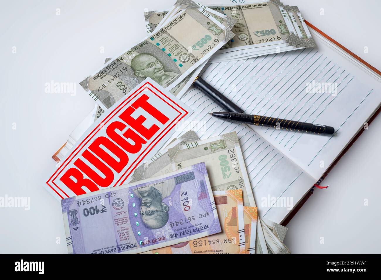 Budget planning concept: Notebook, pen and money on white background ...