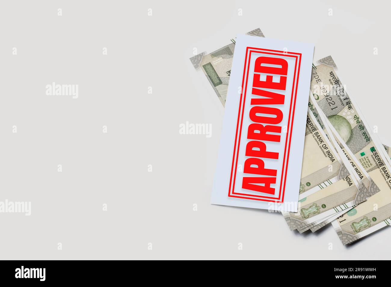 Bank loan approval concept - Indian currency and red stamp on white ...