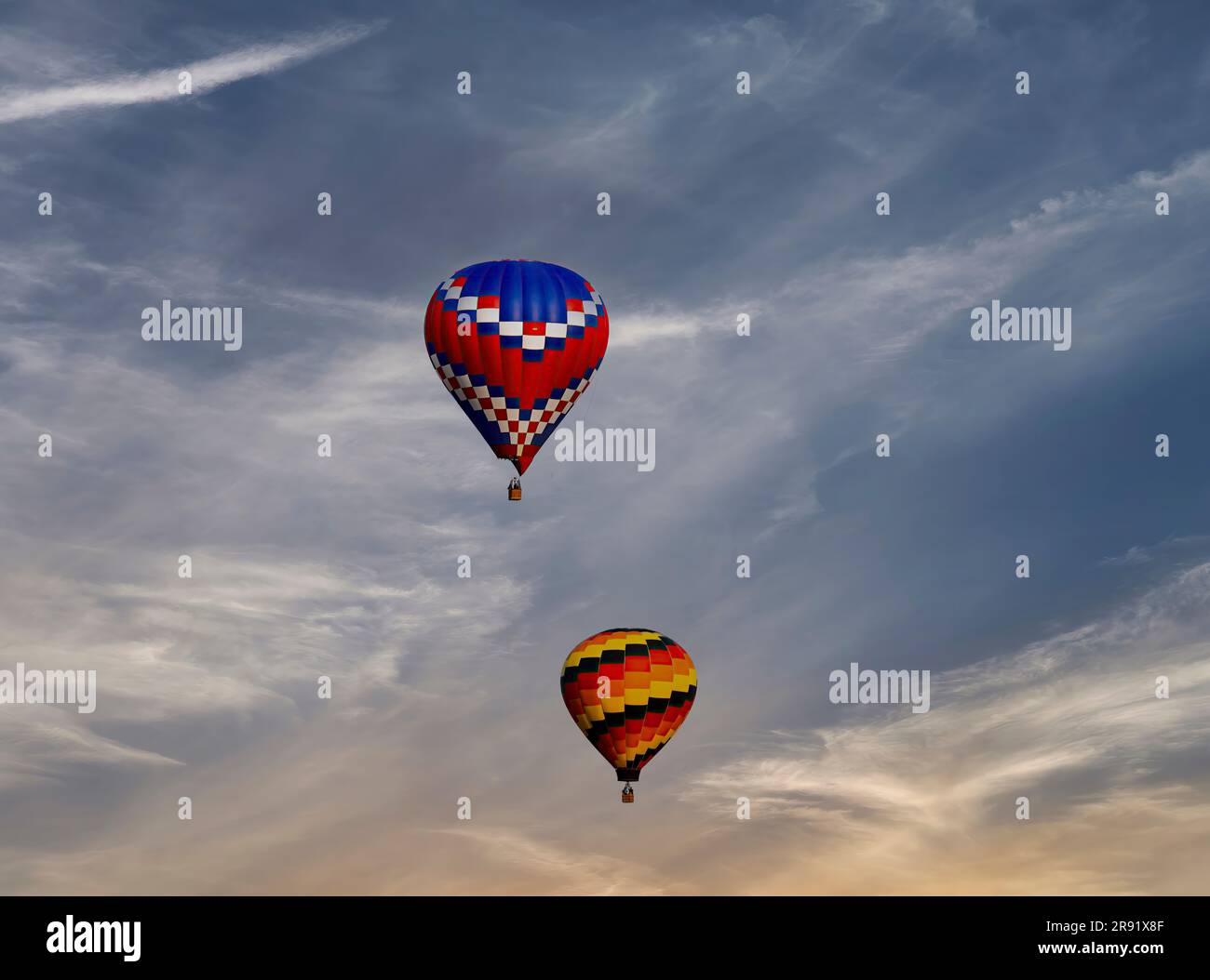 A View of Two Multi Colored Hot Air Balloons Floating in a Beautiful ...