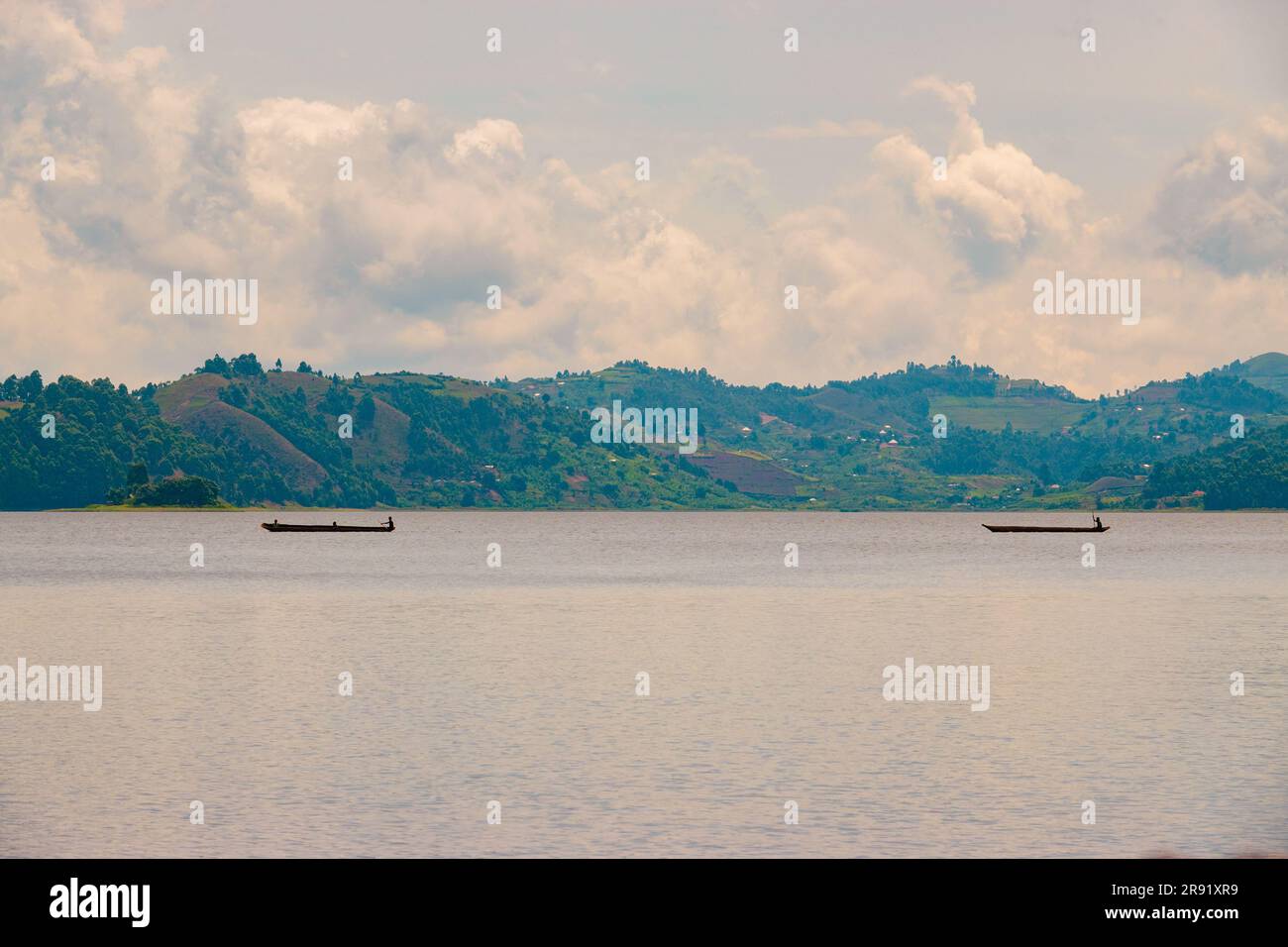 A fisherman on a traditional fishing canoe at Lake Mutanda, Uganda ...