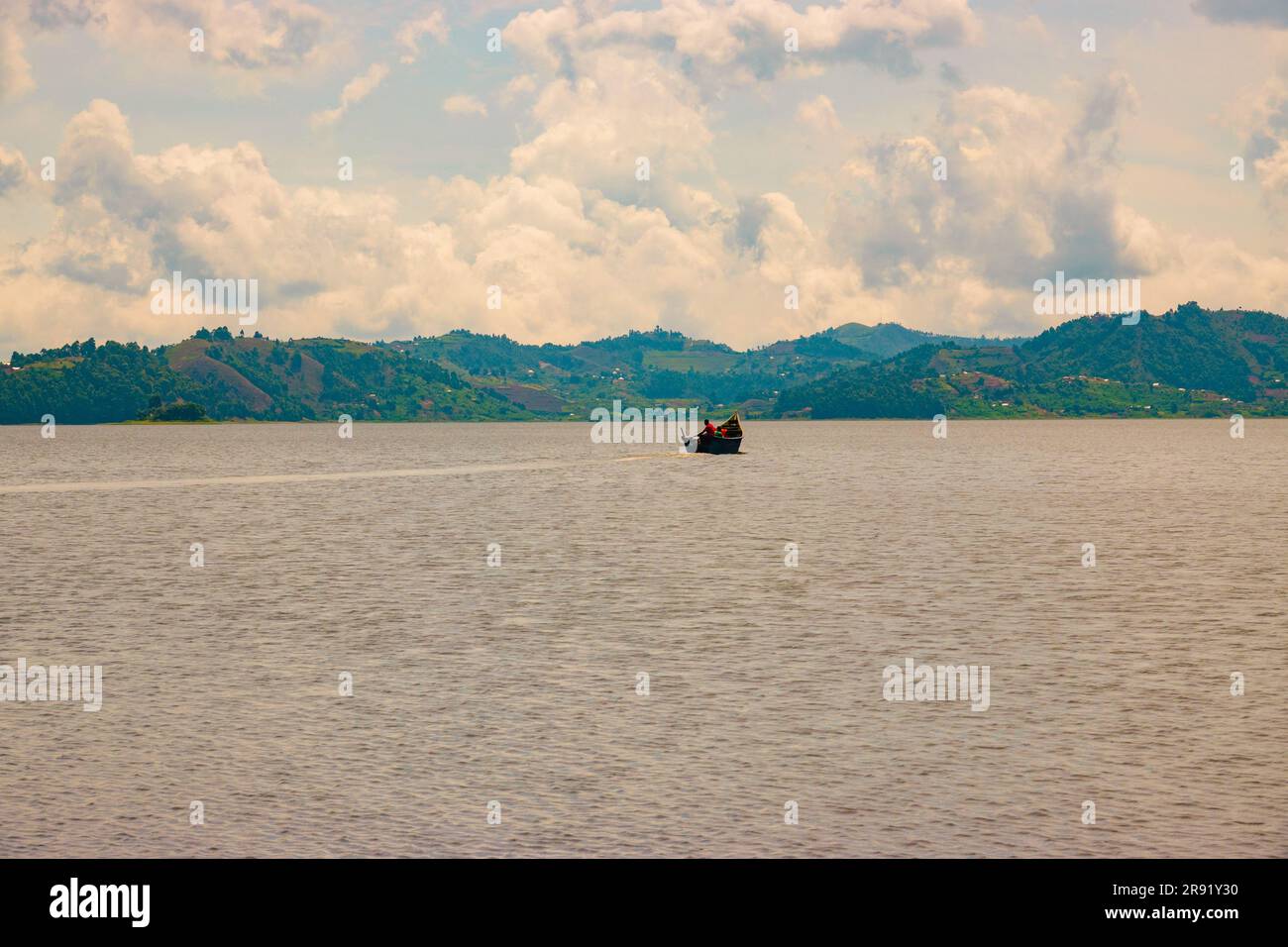 A fisherman on a traditional fishing canoe at Lake Mutanda, Uganda ...