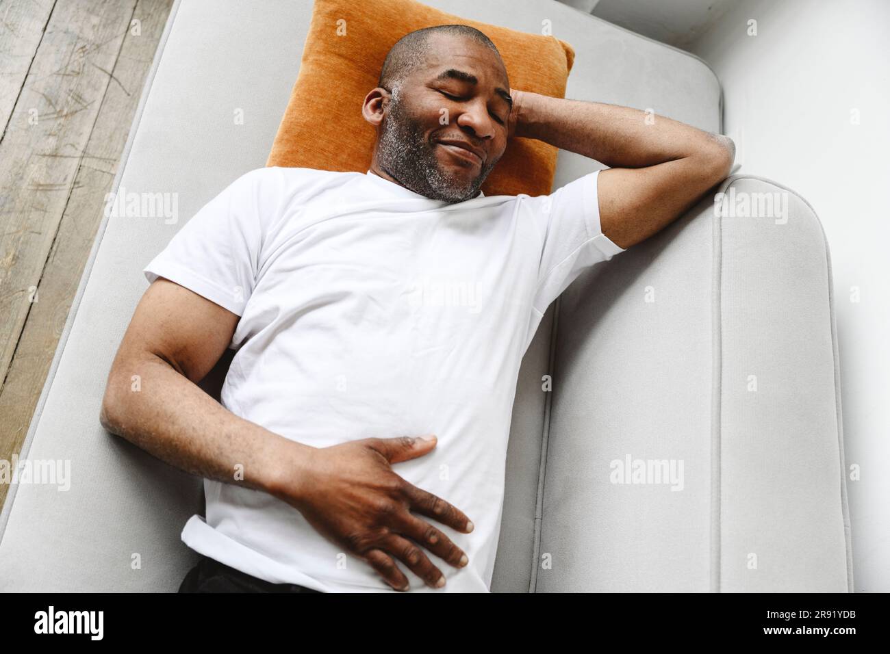 Man sleeping on sofa hi-res stock photography and images - Alamy