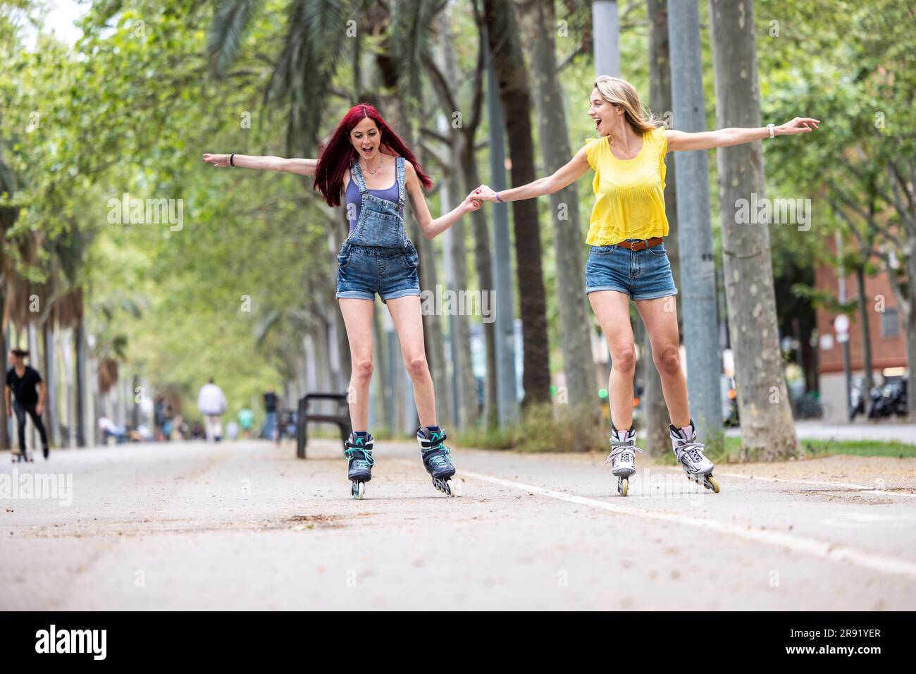 Friends on skates holding hands hi-res stock photography and images - Alamy