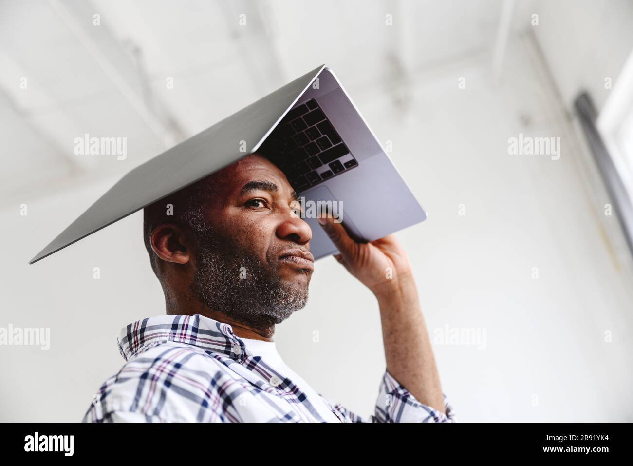 Laptop on head hi-res stock photography and images - Alamy
