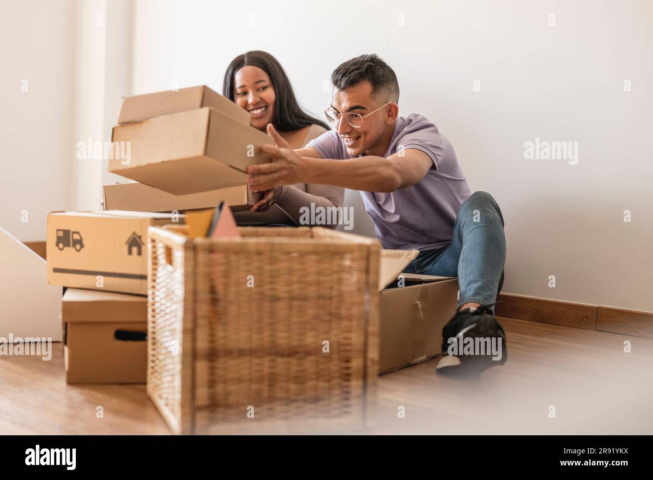 Couple unpacking cardboard boxes in new home Stock Photo - Alamy