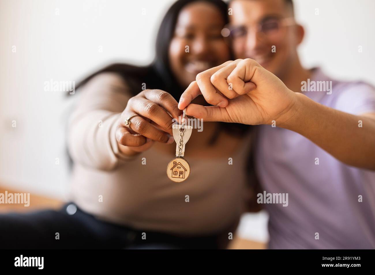 Couple holding house key in new home Stock Photo - Alamy