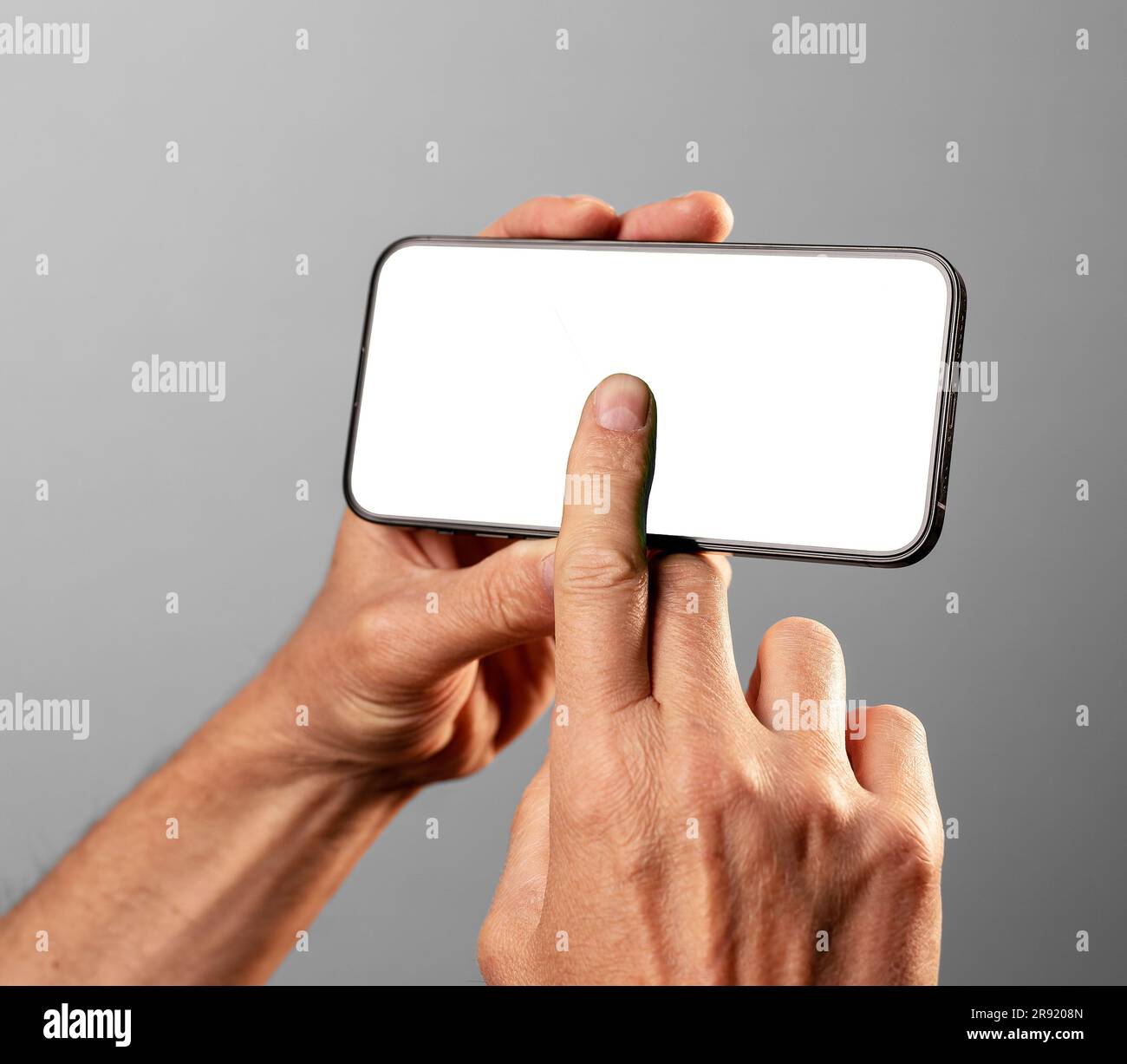 Hand holding smart phone, finger clicking on blank screen mock-up ...