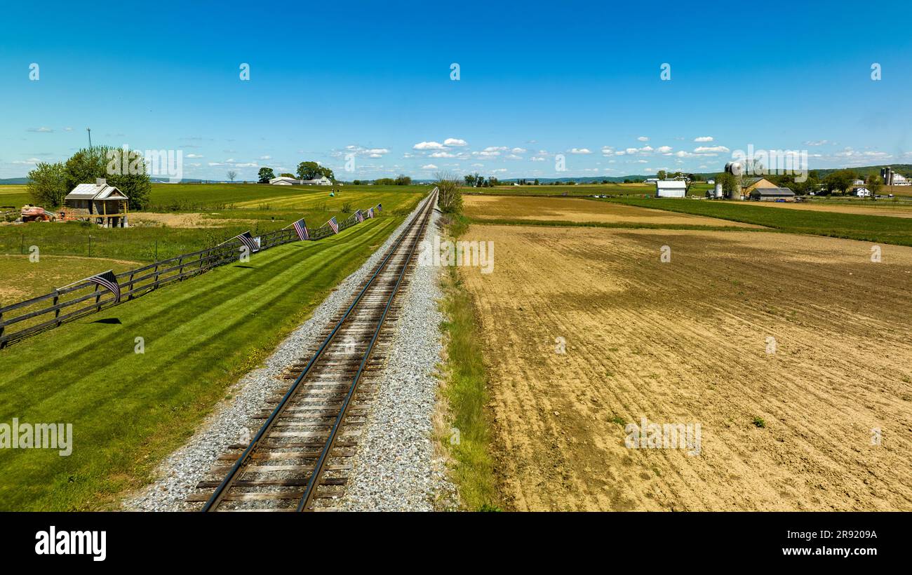 An Aerial View of a Single Rail Road Track Going Thru Farmlands With a ...