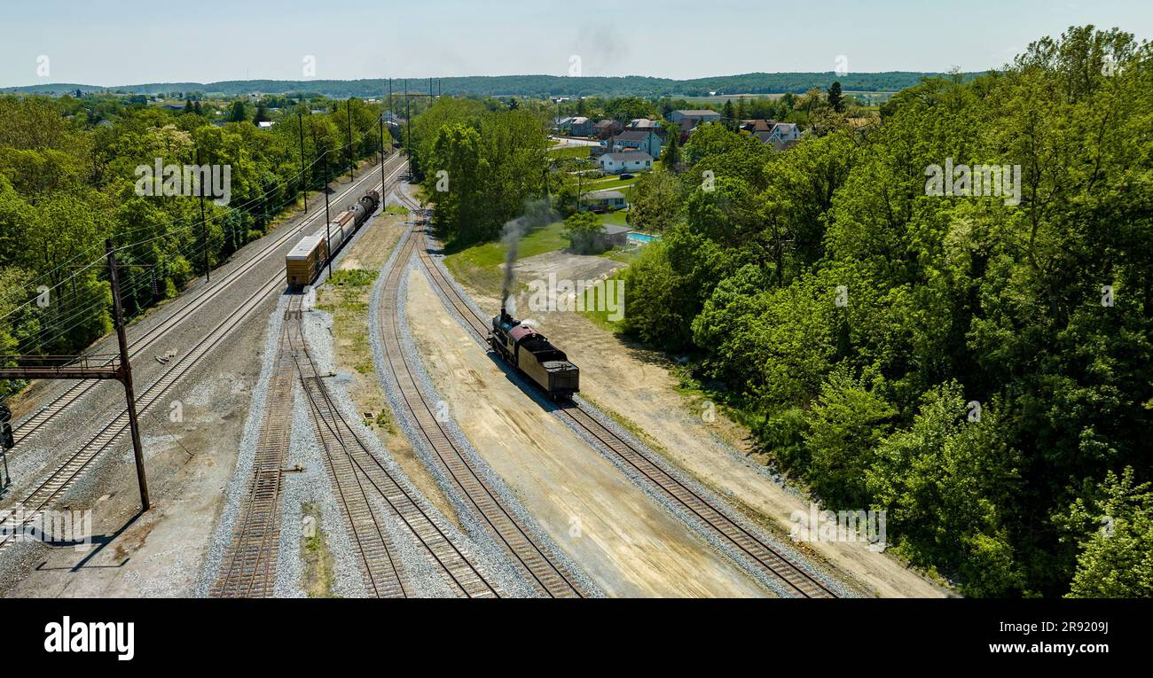 An Aerial View of a Steam Locomotive Moving Freight Cars Around in a ...