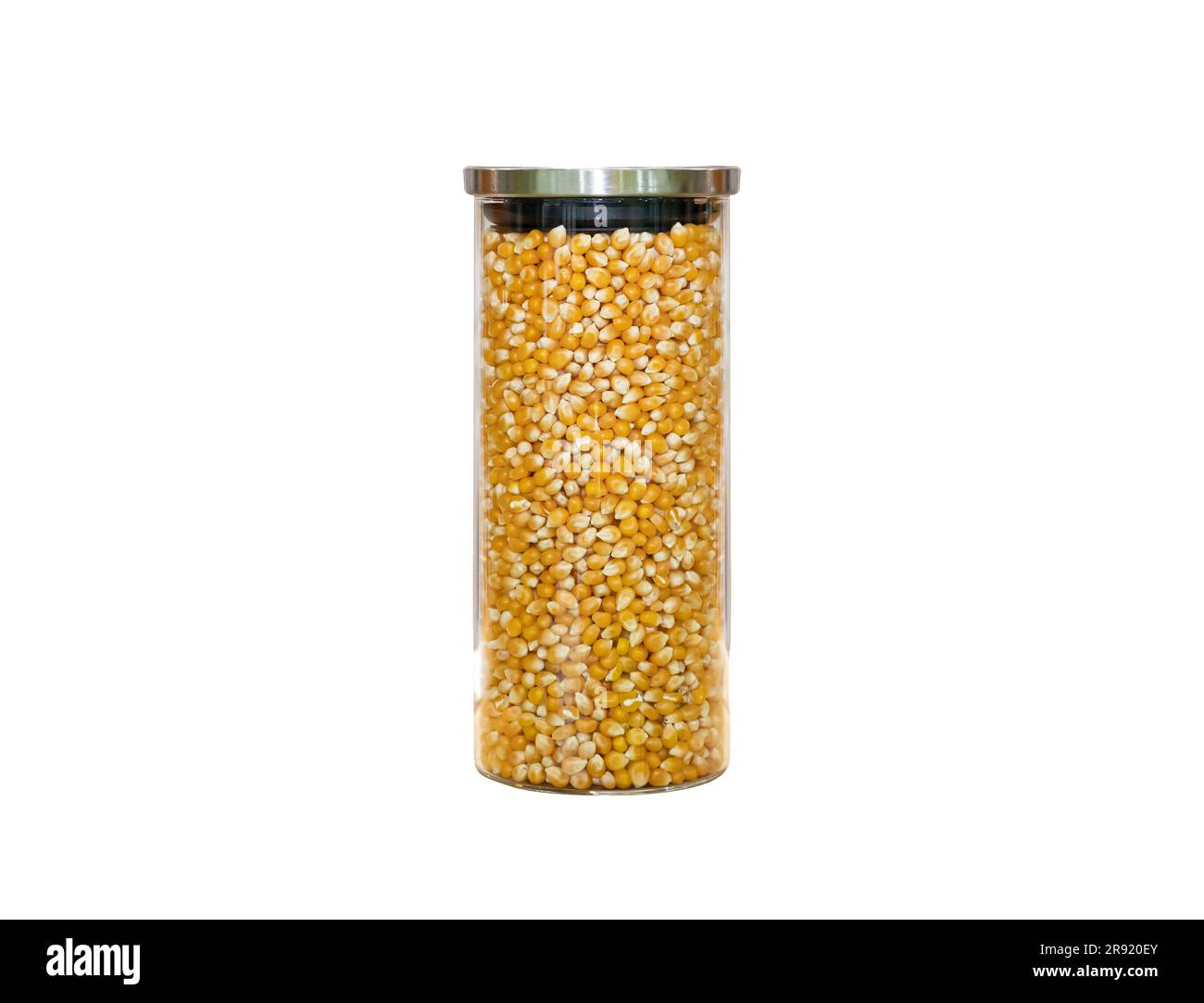A stock photo of a glass container filled with yellow corn kernels ...