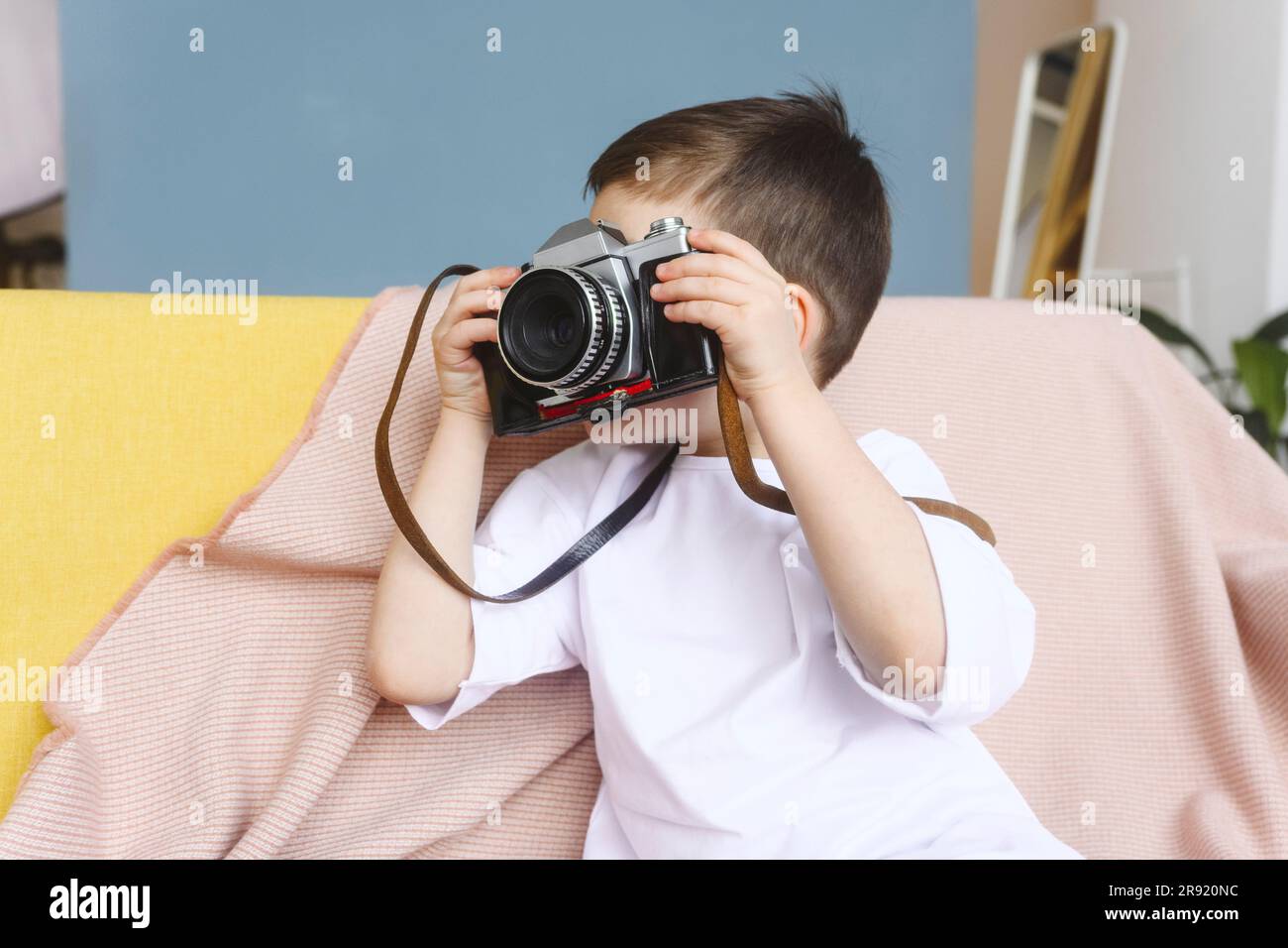 Boy photographing with vintage camera Stock Photo - Alamy