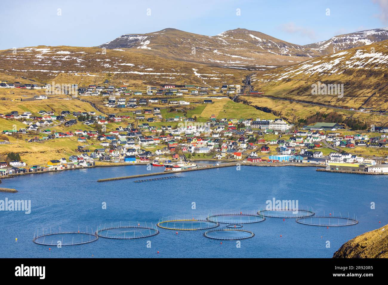 Salmon fish farm with townscape and mountains in Vestmanna, Faroe ...