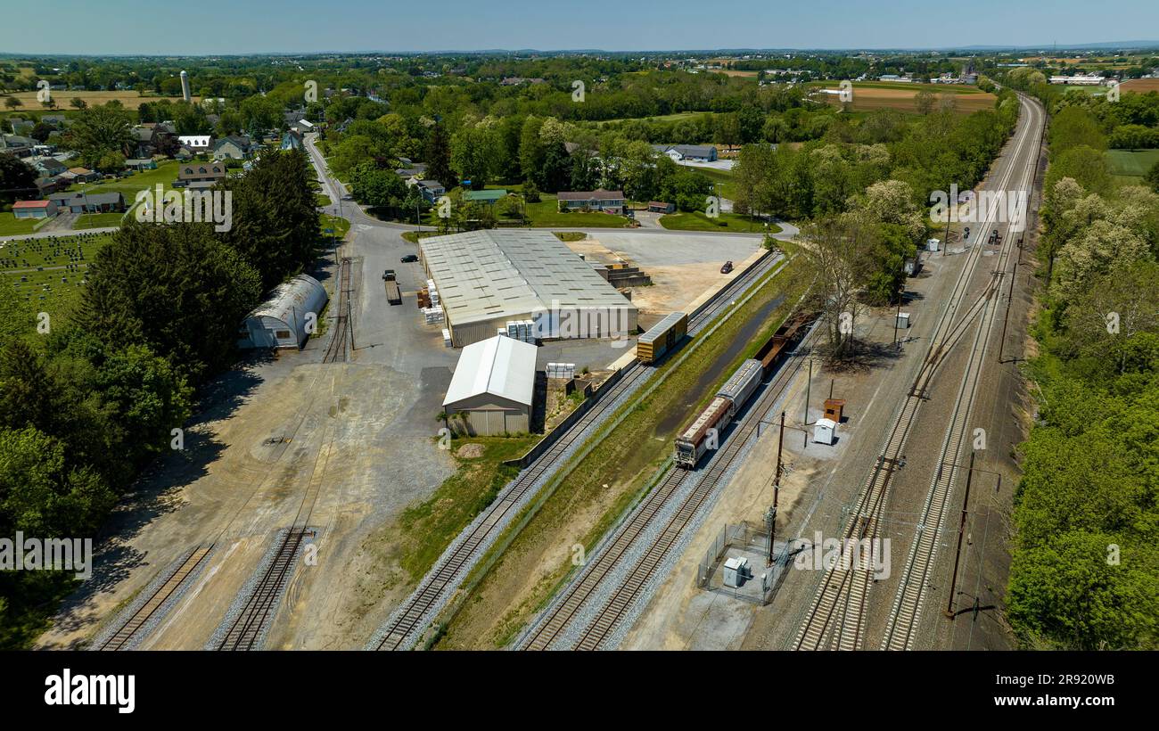 An Aerial View of a Steam Locomotive Moving Freight Cars Around in a ...