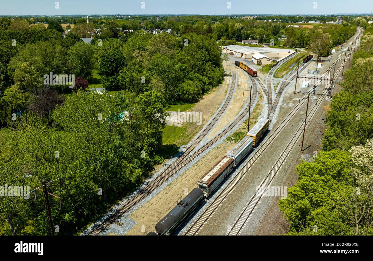 An Aerial View of a Steam Locomotive Moving Freight Cars Around in a ...
