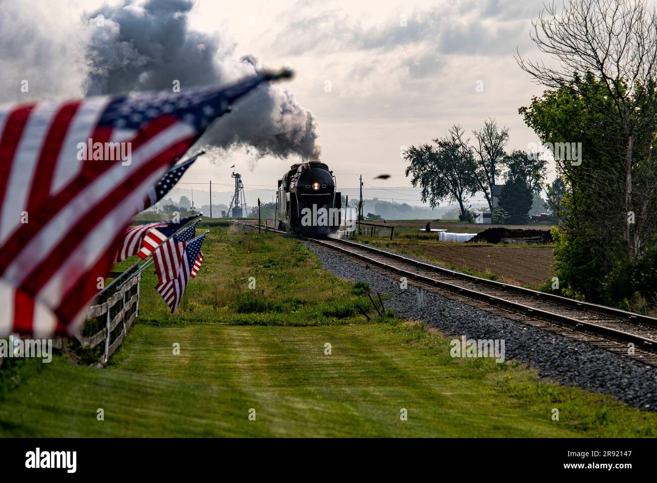 A Steam Locomotive Approaching Blowing Lots of Smoke With a America ...