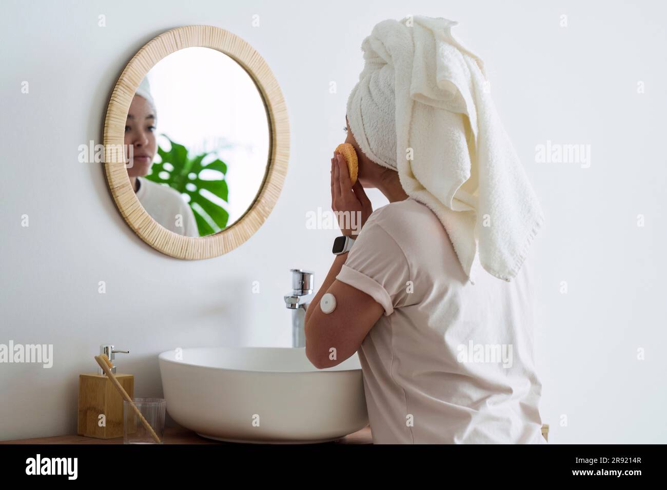 Woman with diabetes doing morning routine in bathroom at home Stock ...