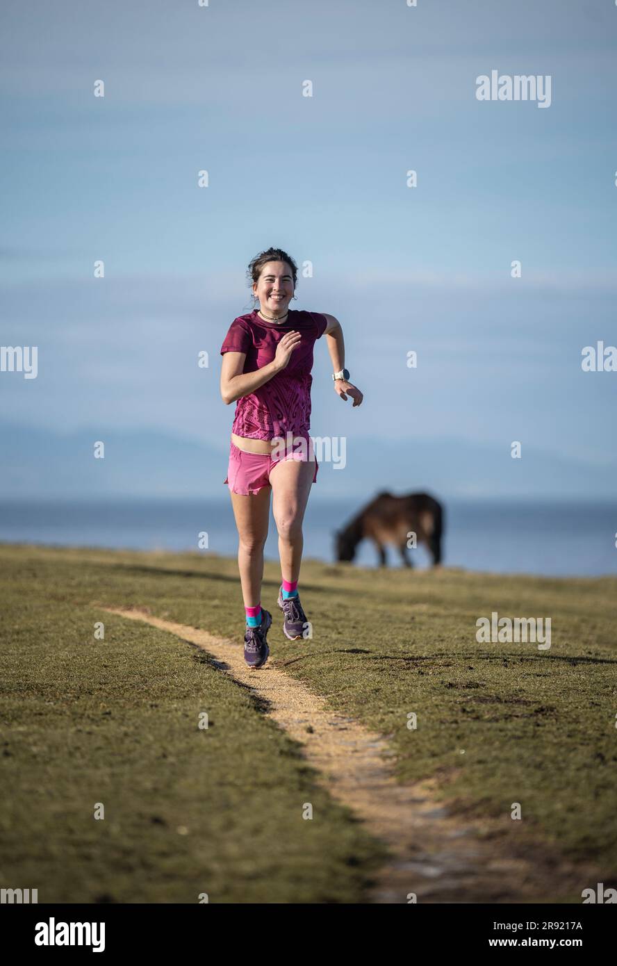 Woman running on path smiling hi-res stock photography and images - Alamy