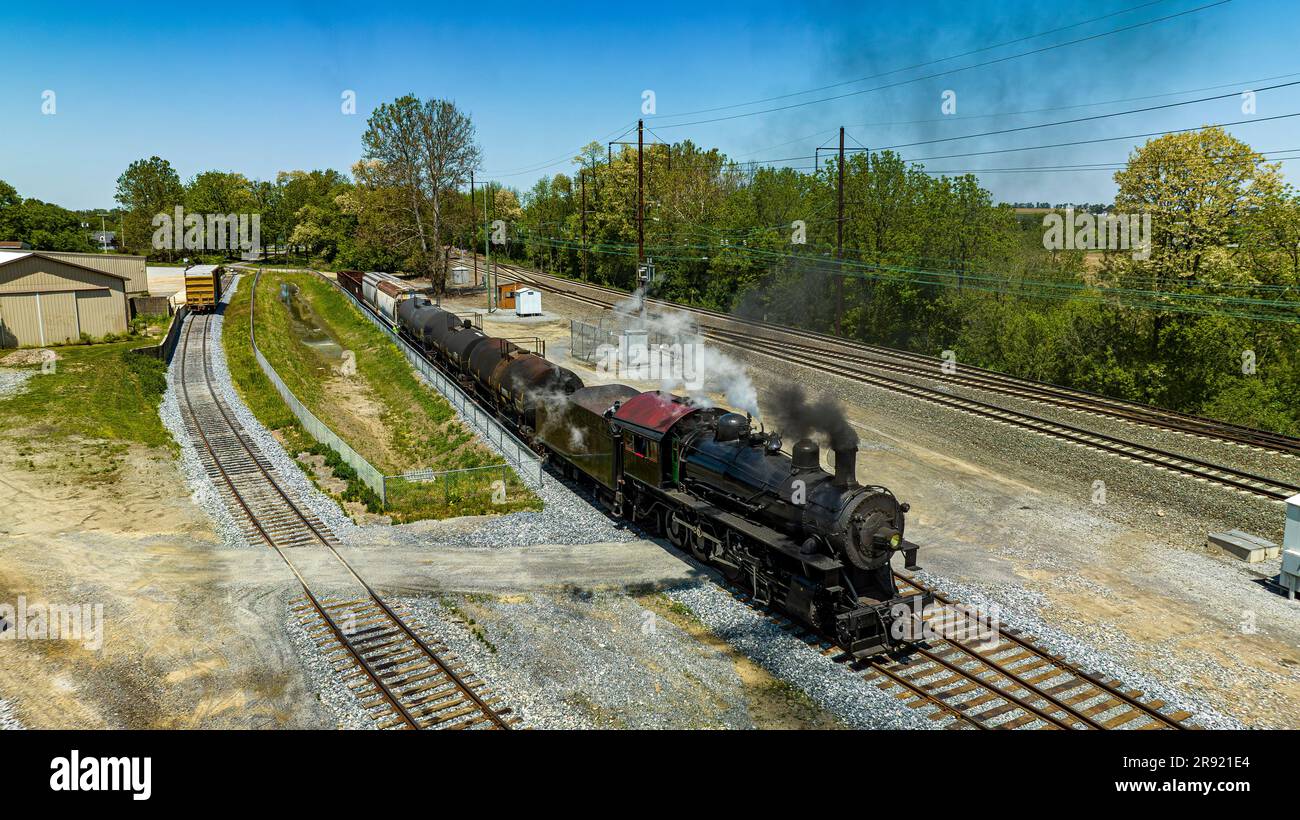 An Aerial View of a Steam Locomotive Moving Freight Cars Around in a ...