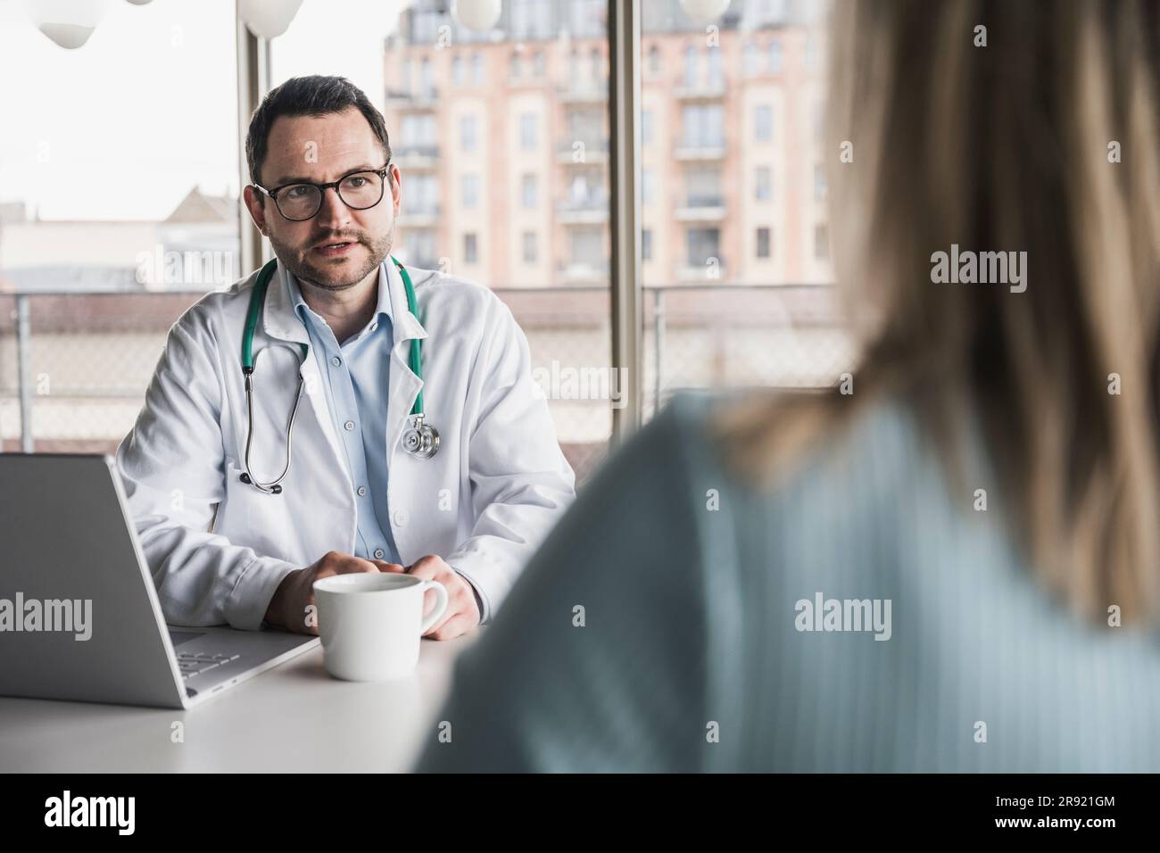 Doctor advising male patient hi-res stock photography and images - Alamy