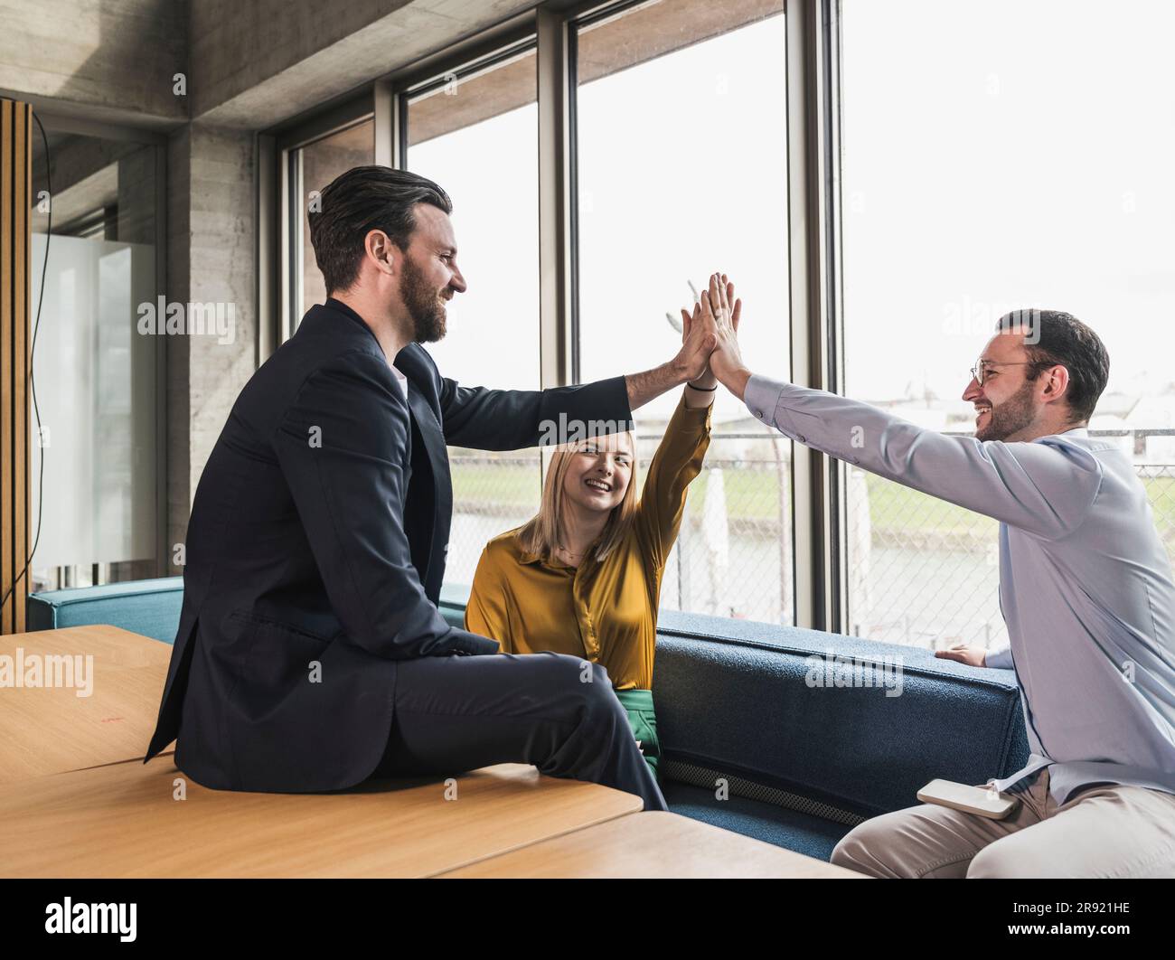 Happy colleagues giving high hi-res stock photography and images - Alamy