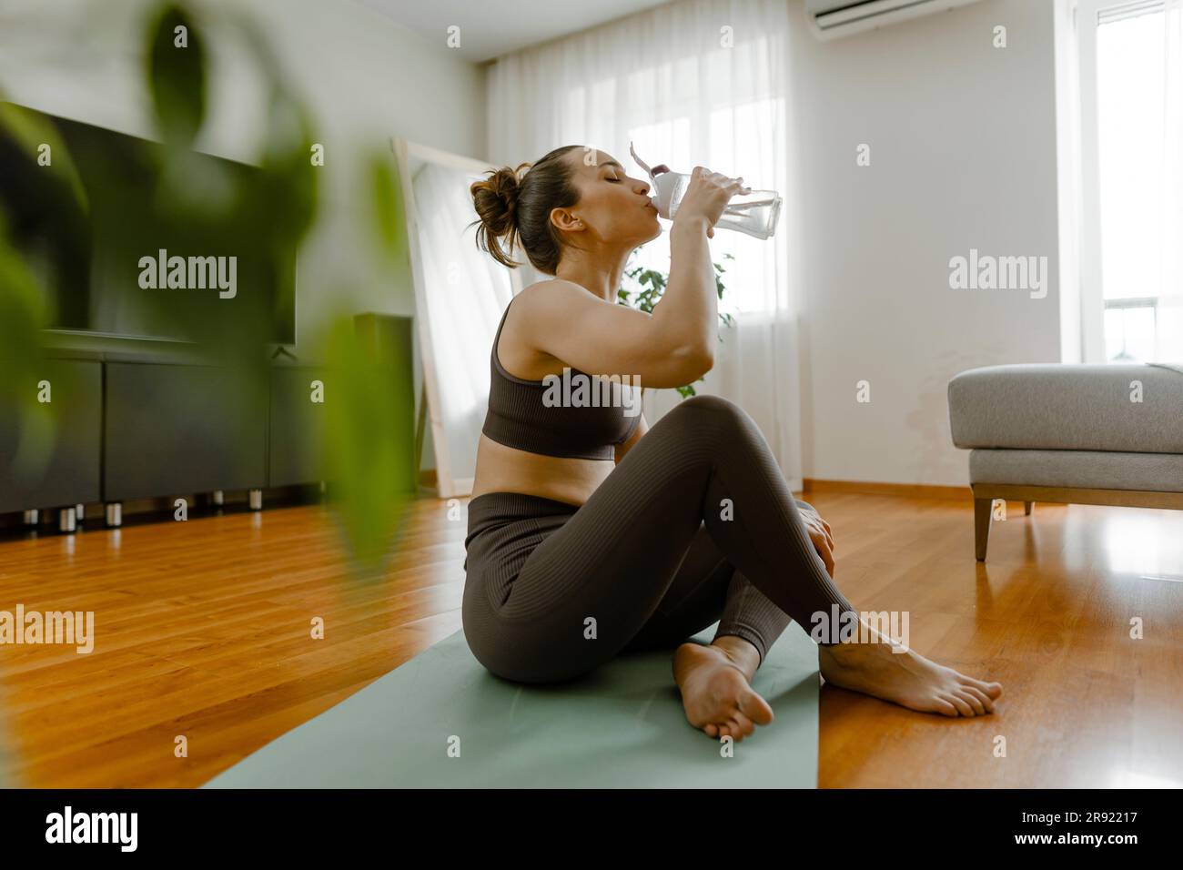 Woman exercising home taking break hi-res stock photography and images - Alamy