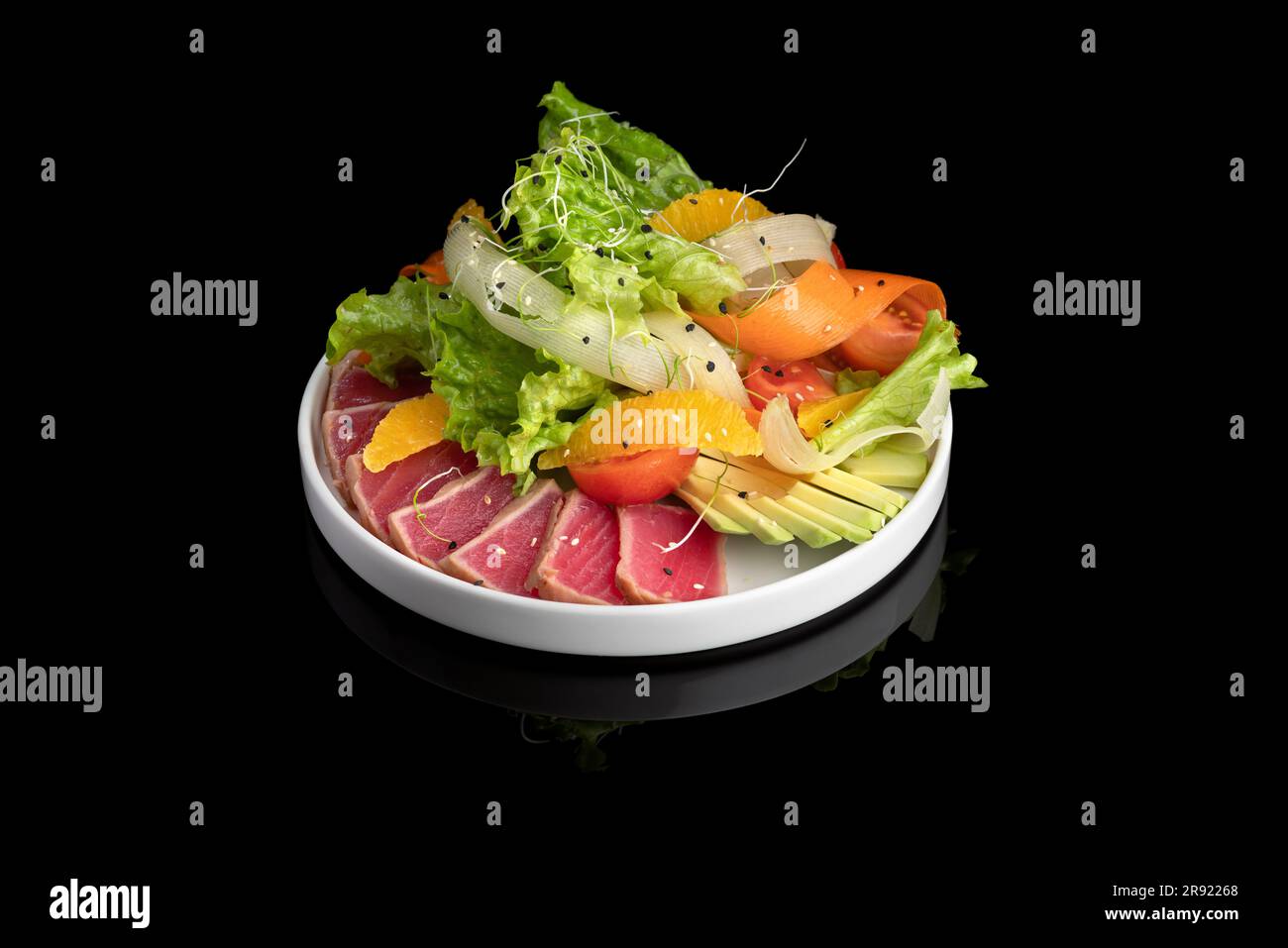 rare seared Ahi tuna slices with fresh vegetable salad on a plate Stock ...