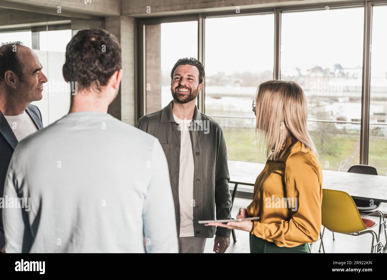 Team appreciating colleague in office Stock Photo - Alamy