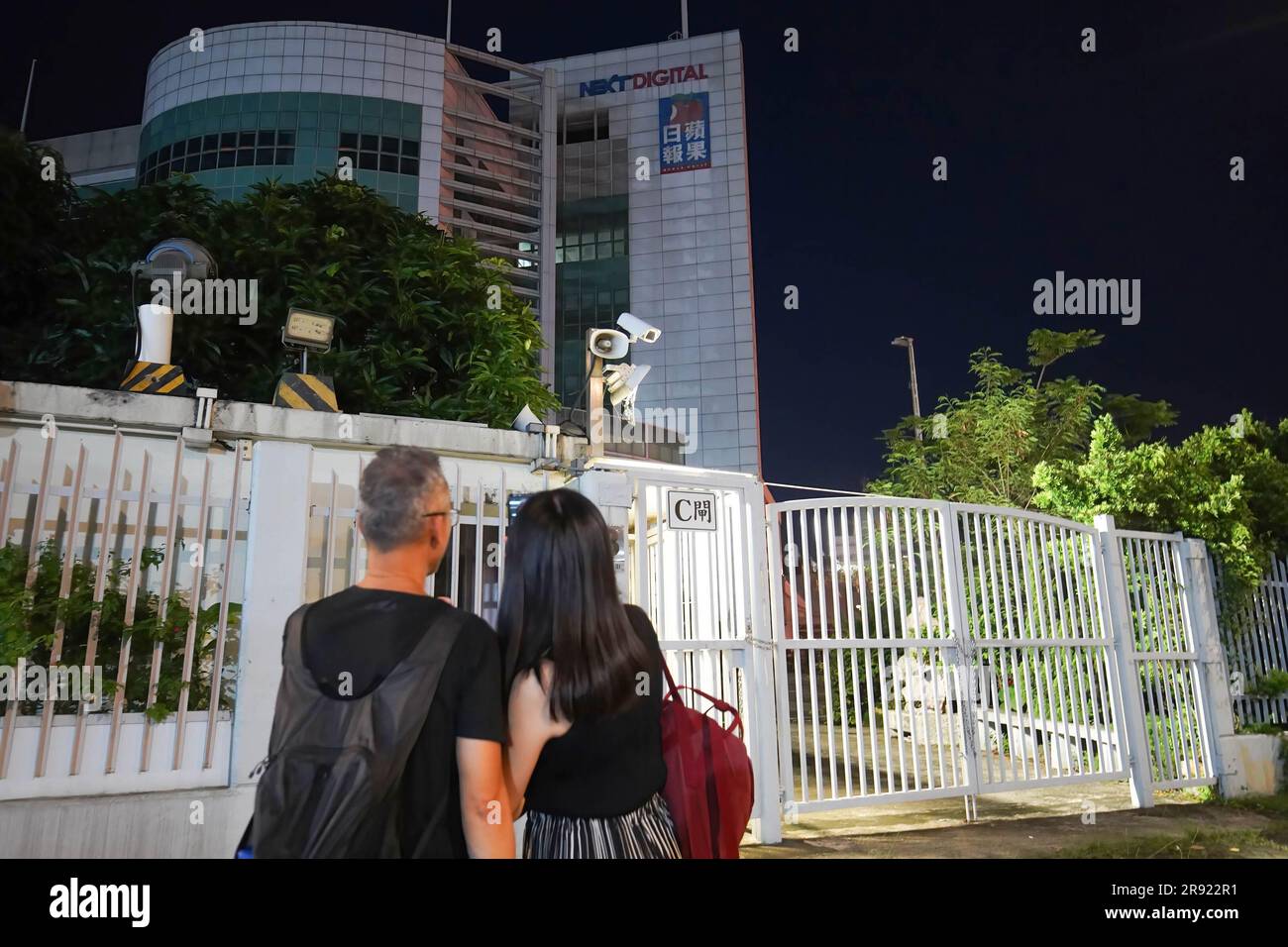 Some former journalists of Apple Daily take photos outside the ...