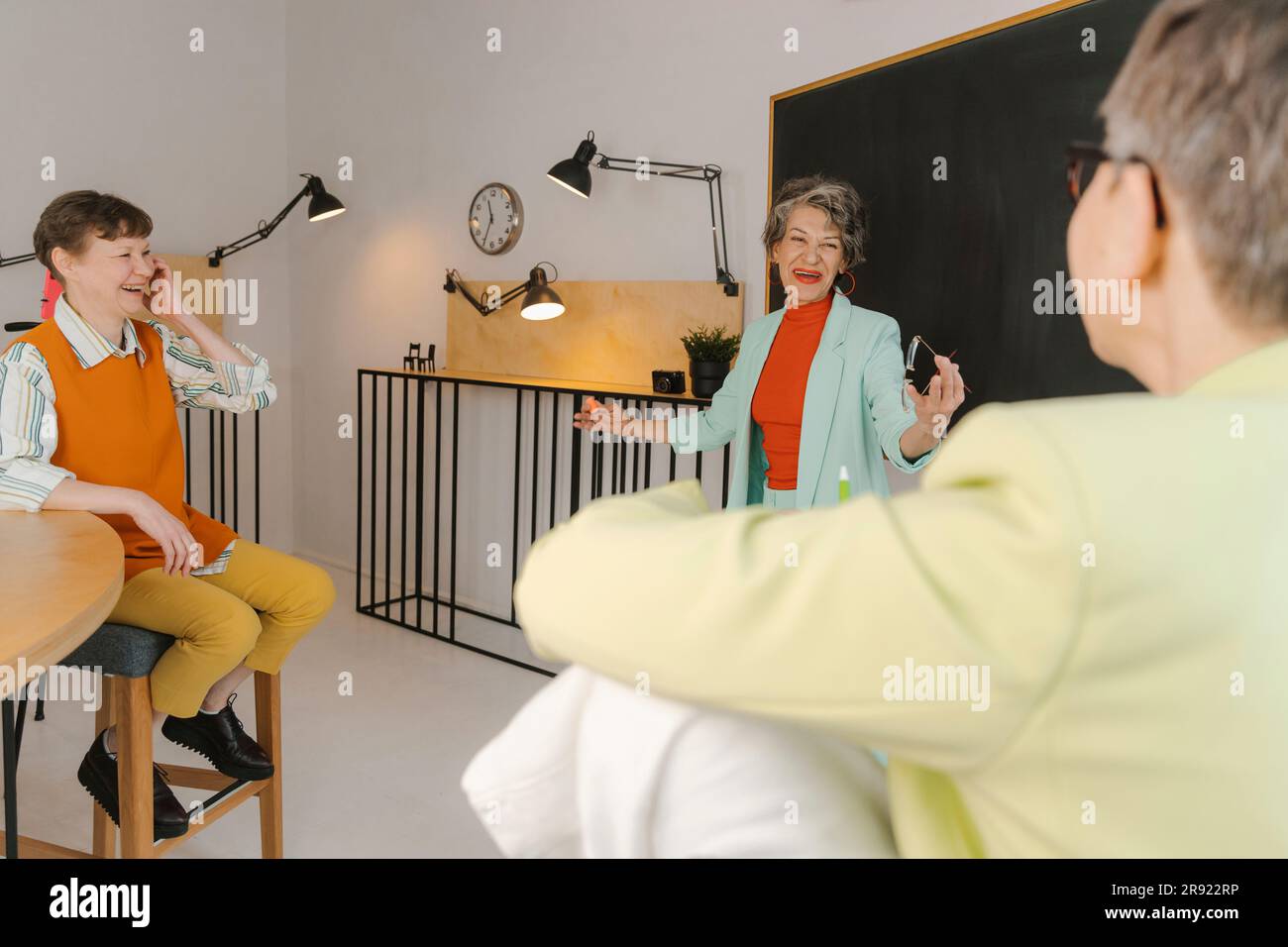 Three talking women sitting in studio and recording video on the camera ...