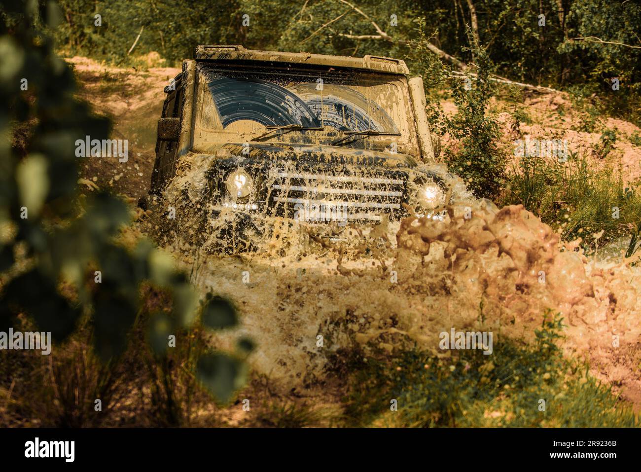 Off-road vehicle goes on the mountain. Mudding is off-roading through ...