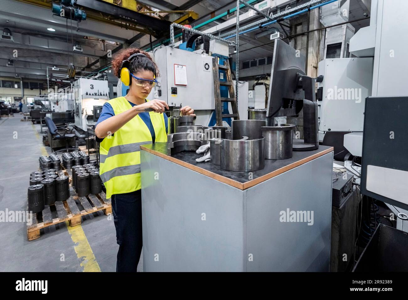 Maintenance engineer in reflective clothing working in modern ...