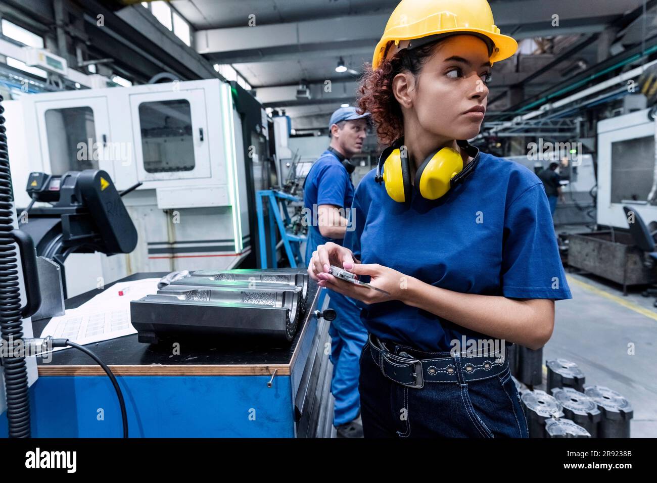 Maintenance engineer working in modern factory using robotics Stock ...