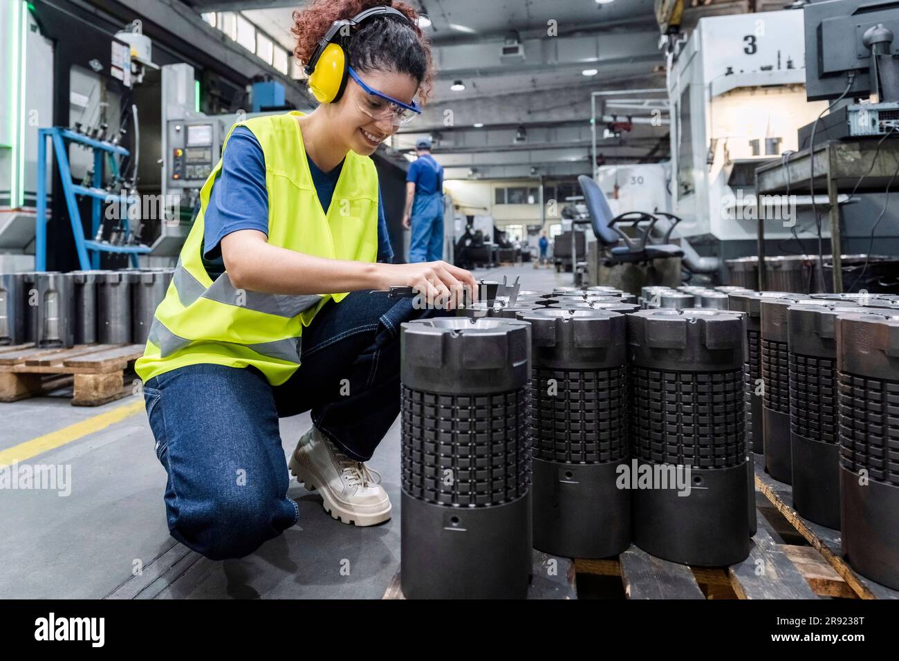 Engineer wearing reflective clothing working in modern factory Stock ...