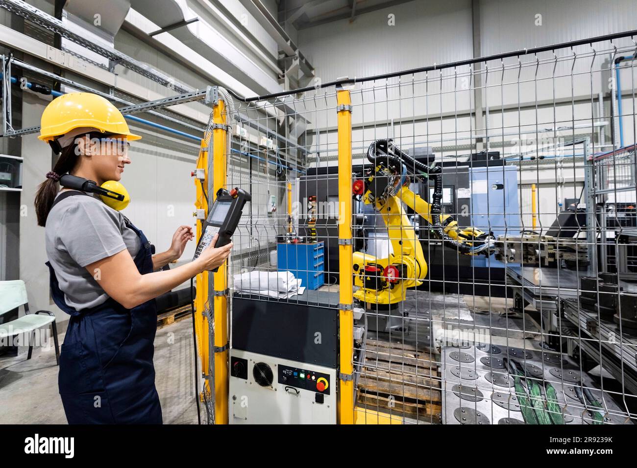 Engineer operating robotic arm in modern factory Stock Photo - Alamy Engineer operating robotic arm in modern factory Stock Photo - Alamy