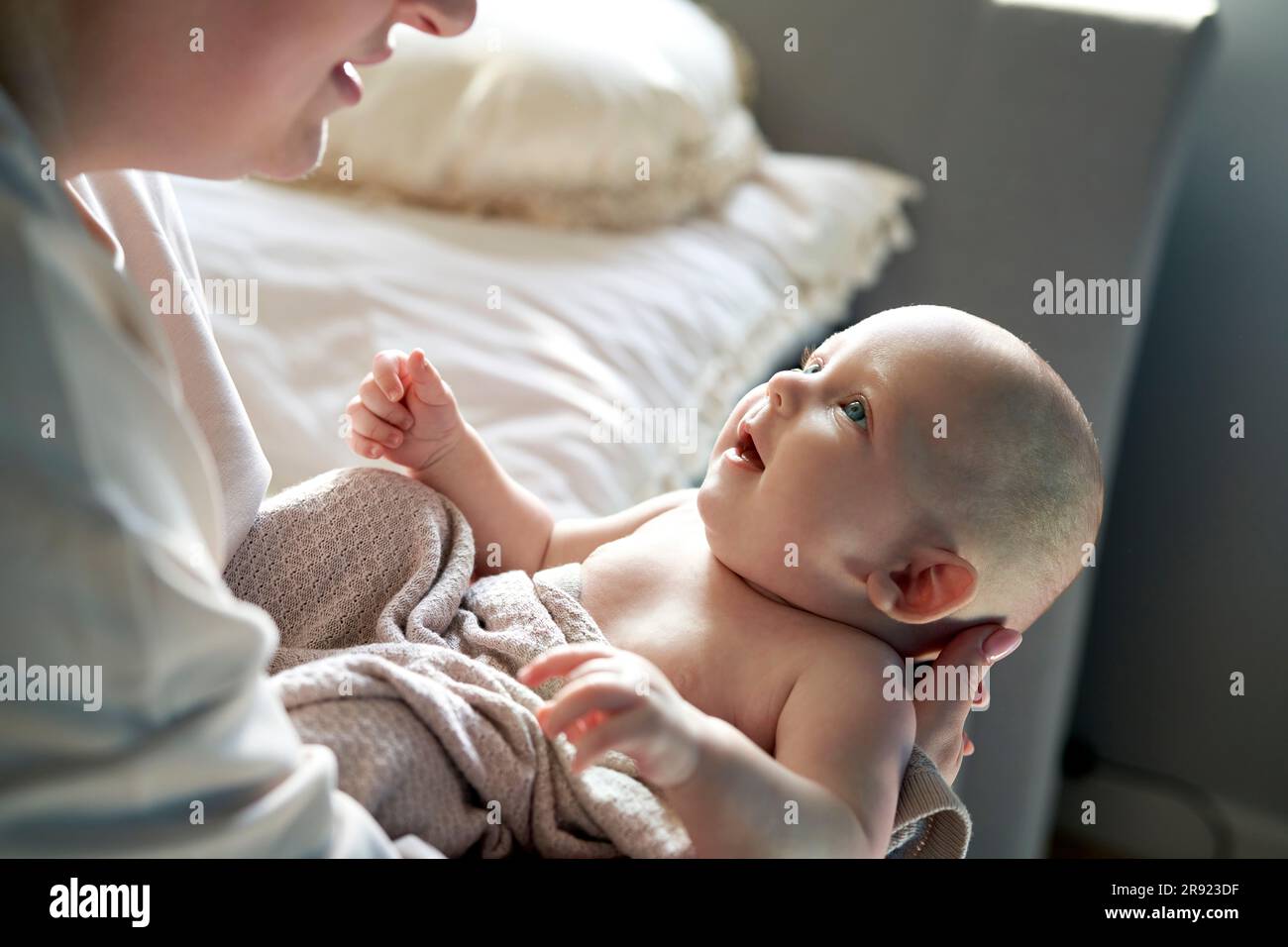 Mother holding cute baby girl at home Stock Photo - Alamy