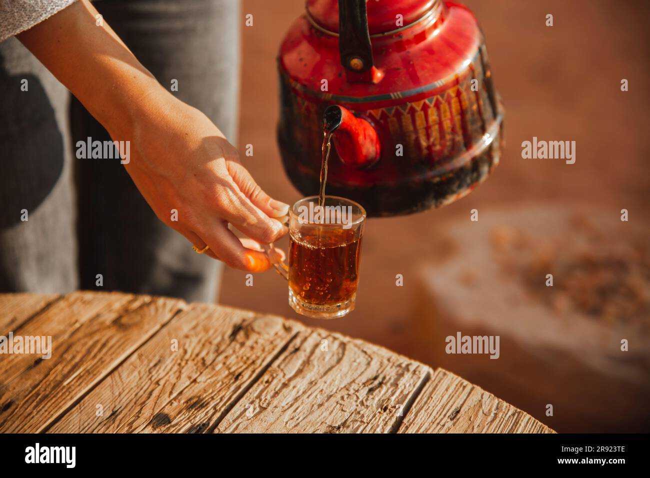 Hands holding teapot hi-res stock photography and images - Alamy