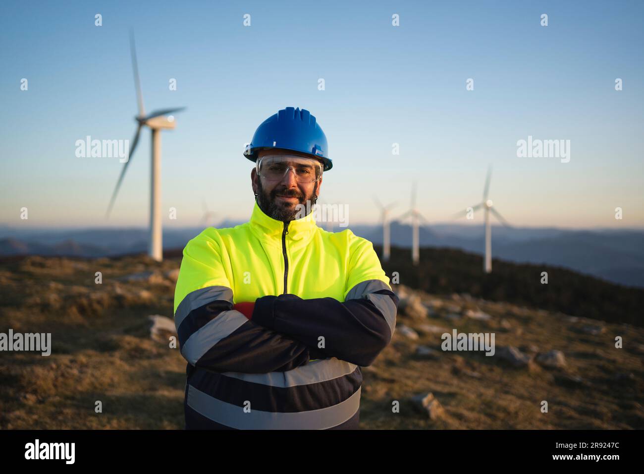Smiling technical engineer with arms crossed Stock Photo - Alamy