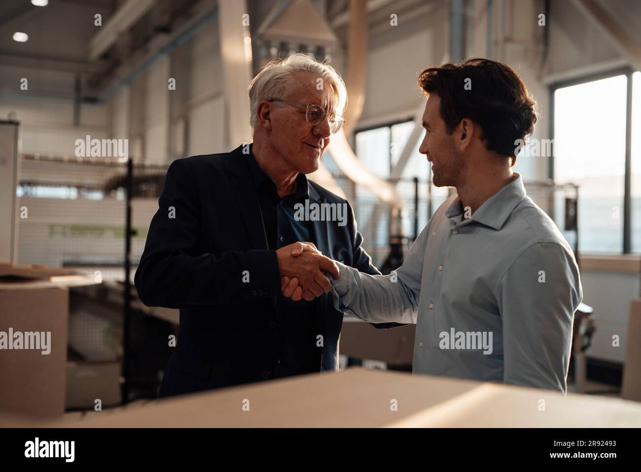 Businessman smiling shaking hands hi-res stock photography and images ...