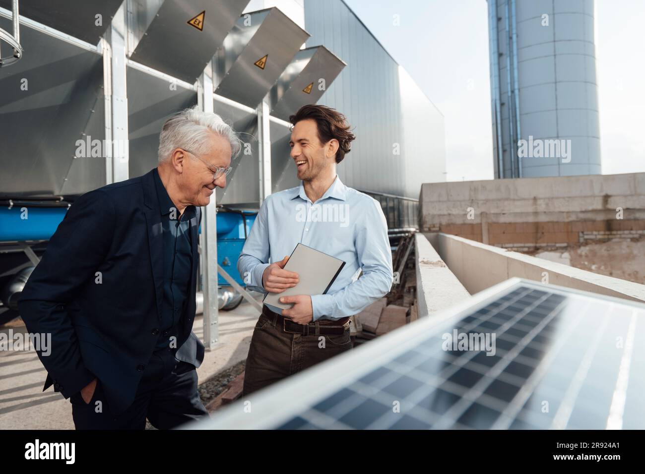 Happy businessmen standing together by solar panel Stock Photo - Alamy