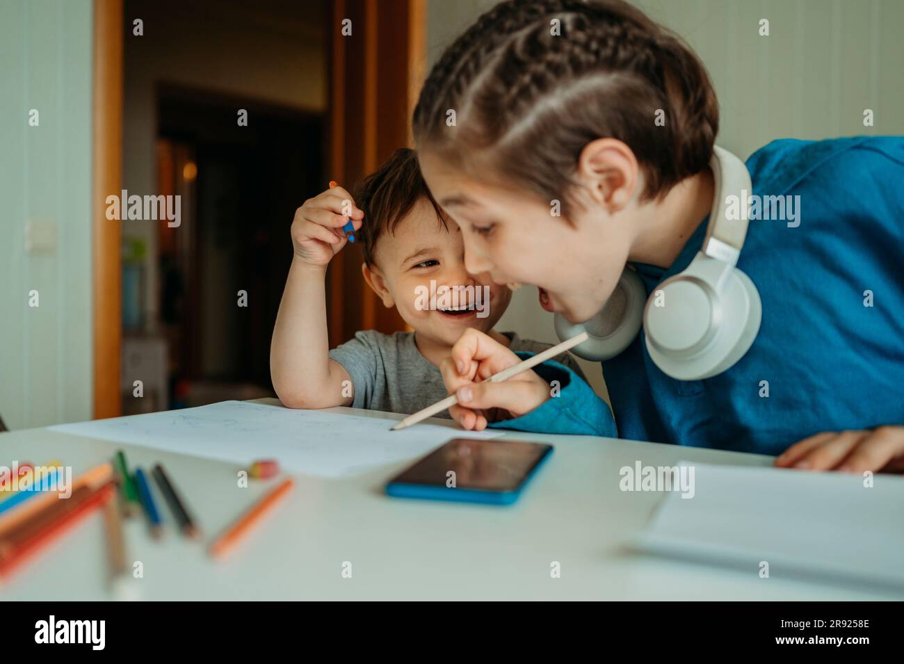 Happy brother having fun doing art at home Stock Photo - Alamy