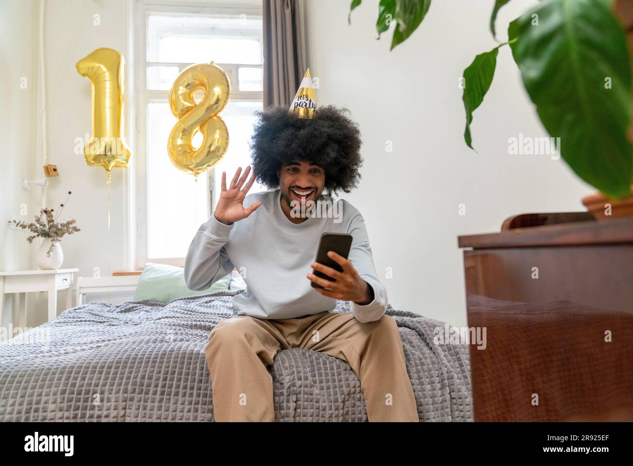 Happy man doing video call celebrating birthday at home Stock Photo - Alamy