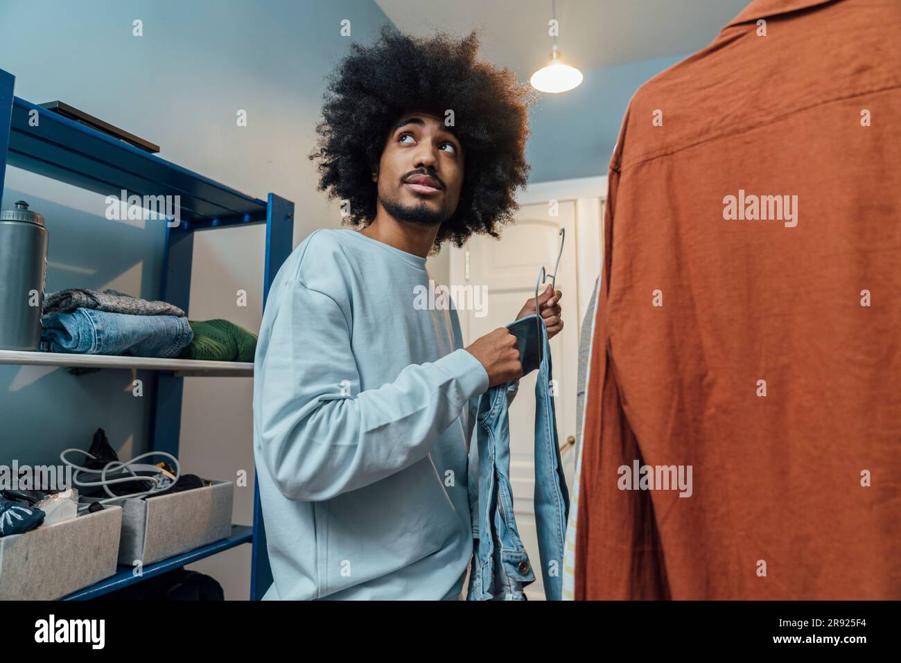 Young man clothes wardrobe hi-res stock photography and images - Alamy