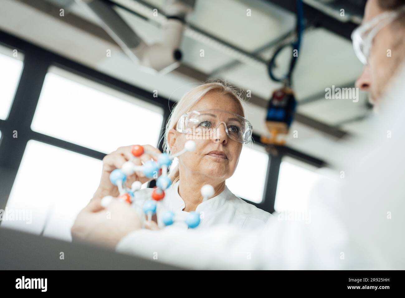 Senior scientist examining molecular structure with colleague in laboratory Stock Photo - Alamy
