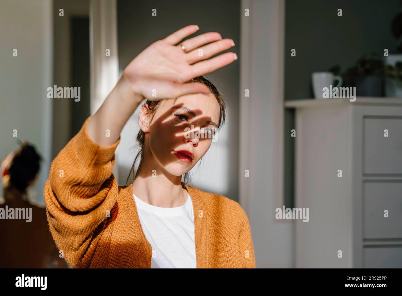 Woman shielding eyes from light hi-res stock photography and images - Alamy