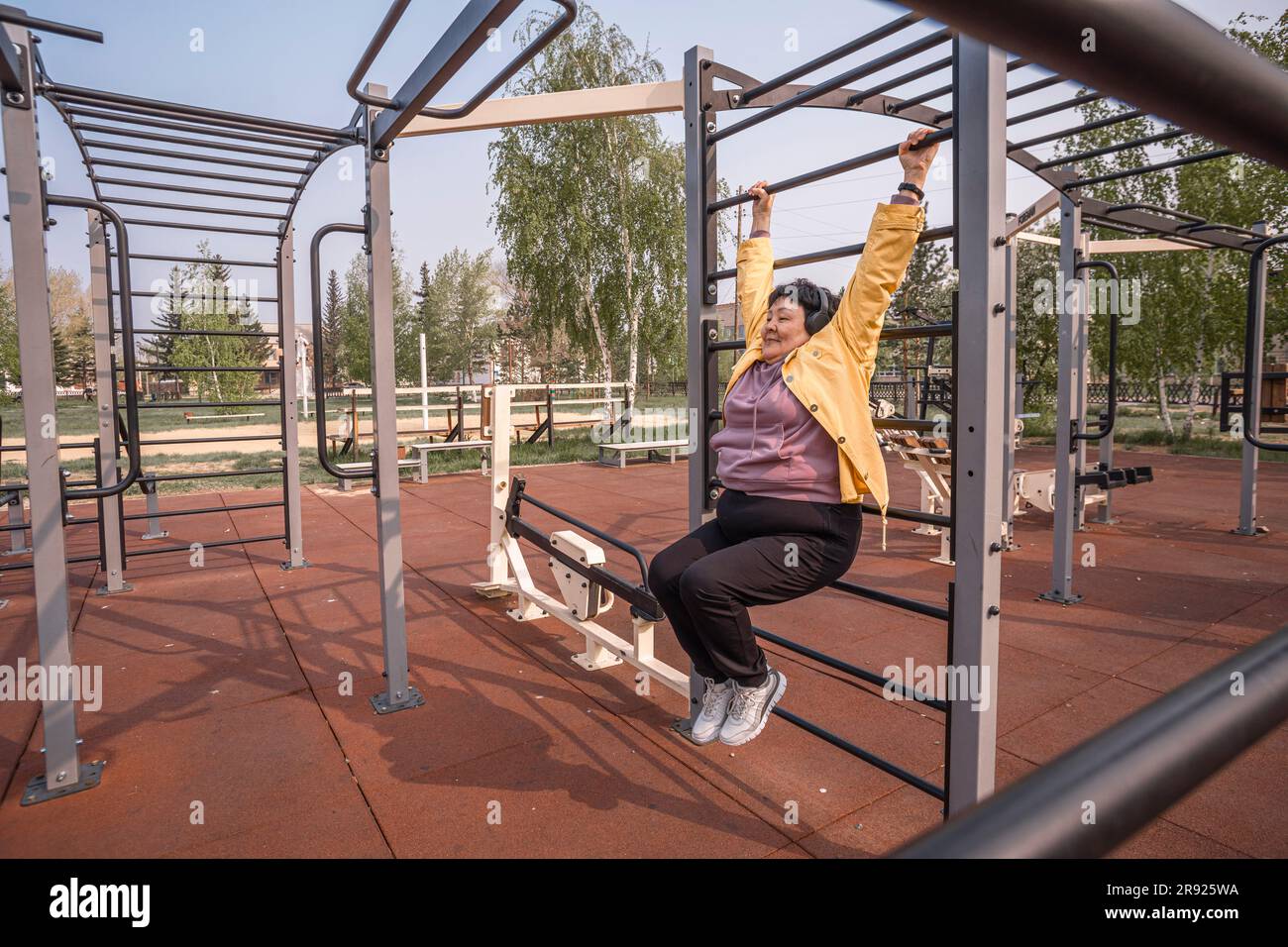 Woman horizontal bar park hi-res stock photography and images - Alamy