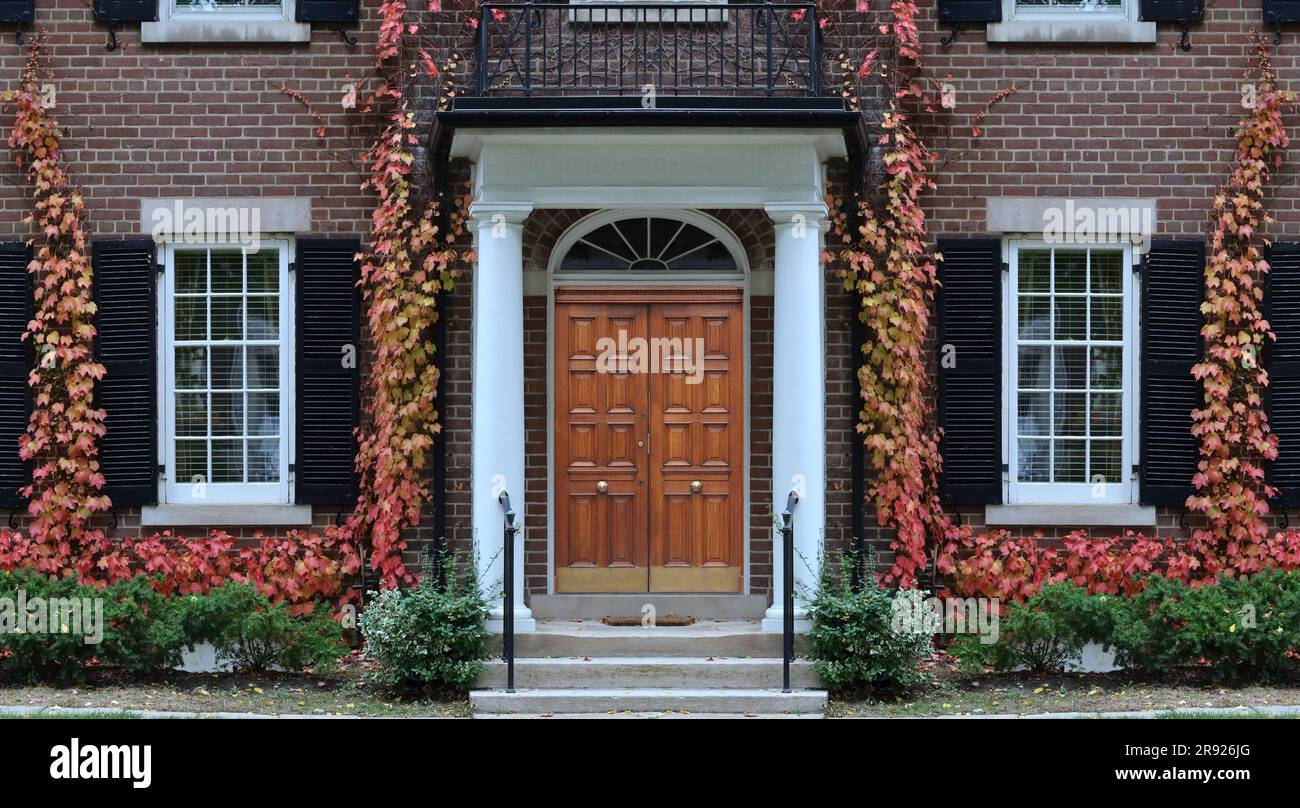 Front door of house surrounded by colorful ivy in fall Stock Photo - Alamy