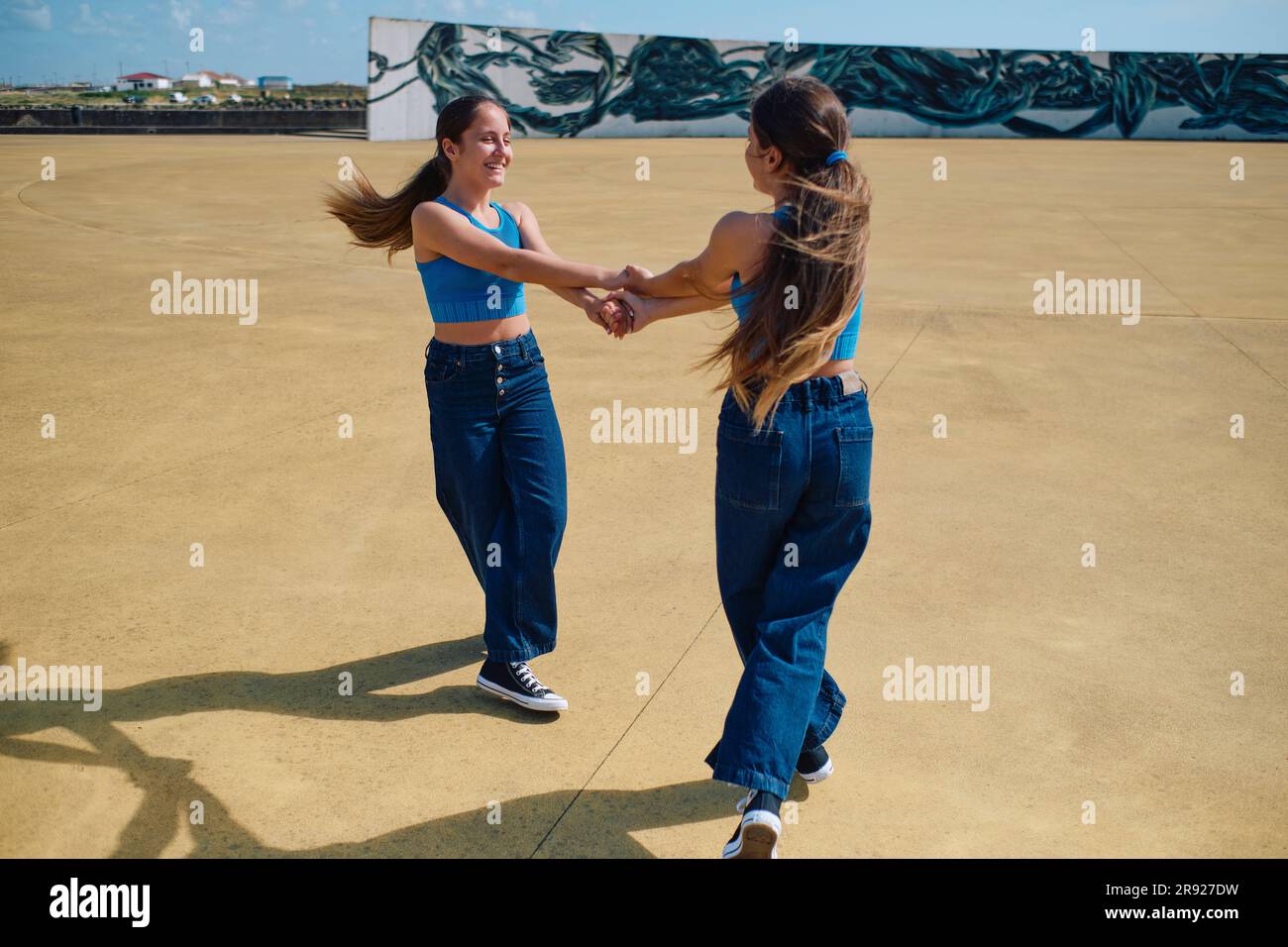 Happy girls holding hands and playing on sunny day Stock Photo - Alamy