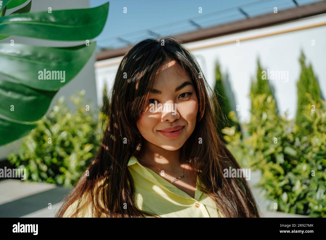 Smiling woman with leaf shadow on face Stock Photo - Alamy