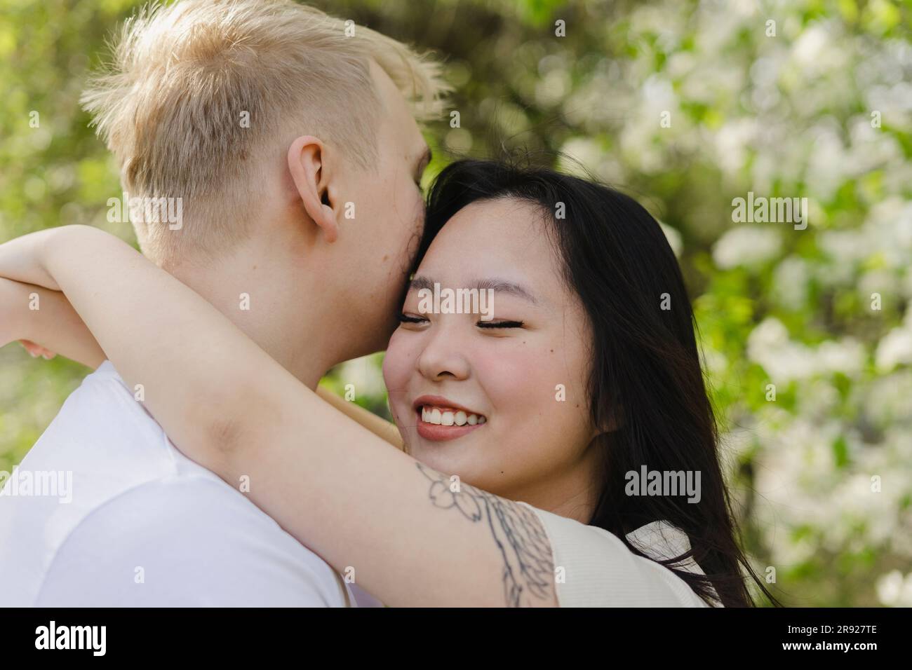 Affectionate young woman embracing hi-res stock photography and images ...