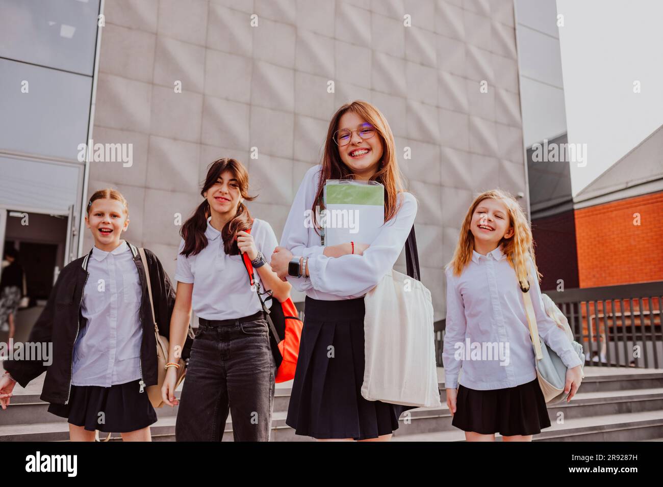 Schoolgirls wearing uniforms standing in front of school building Stock ...
